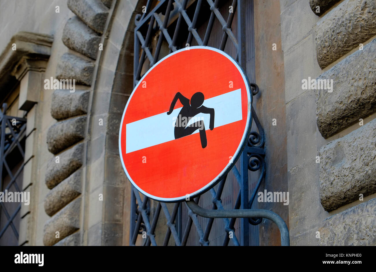 red no entry sign with graphic illustration of man climbing through ...