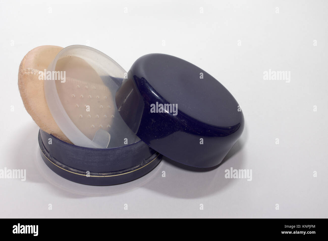 powder boxes, closed and half-open, with sticking out powderpuff. Still ...