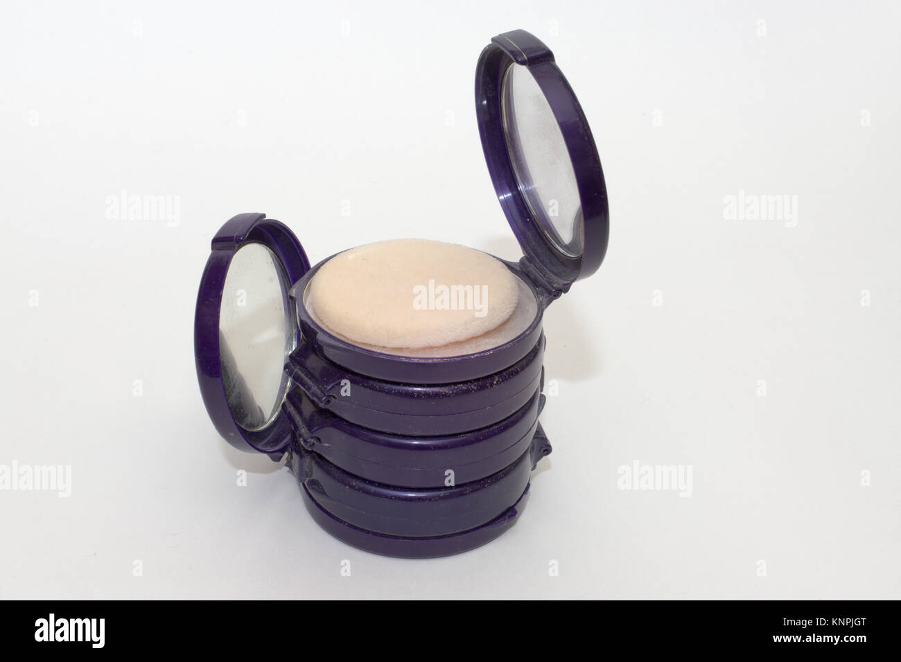 compact powder boxes in a stack, upper and lower cases with powredpuff ...