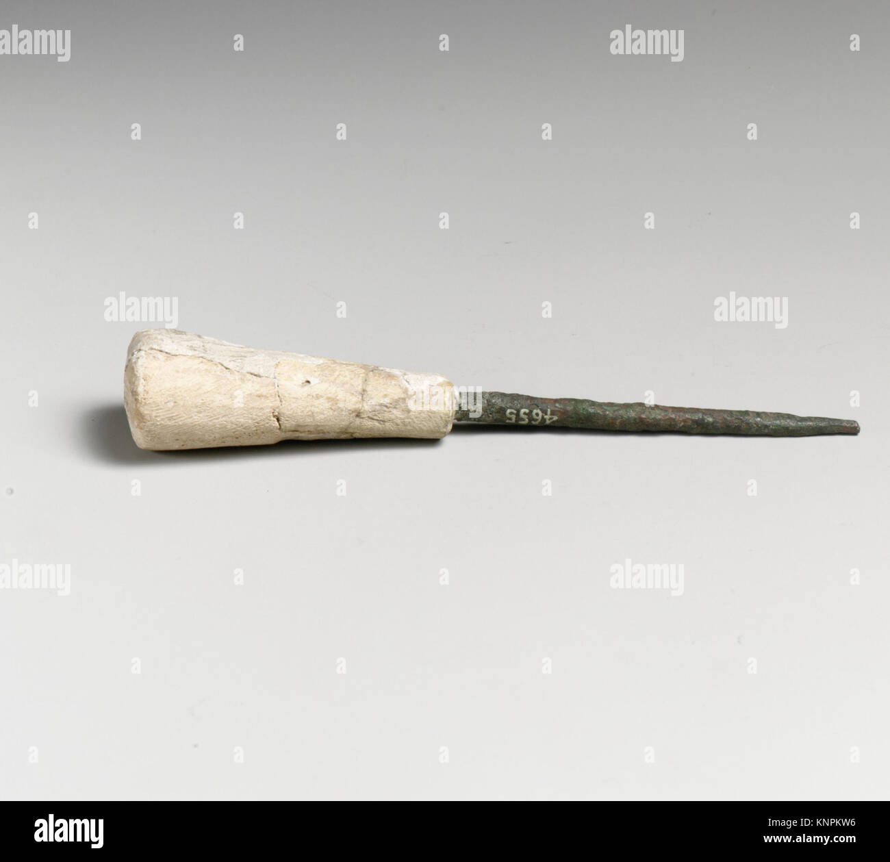 A bronze awl with a bone handle, used as a hand tool in antiquity for ...