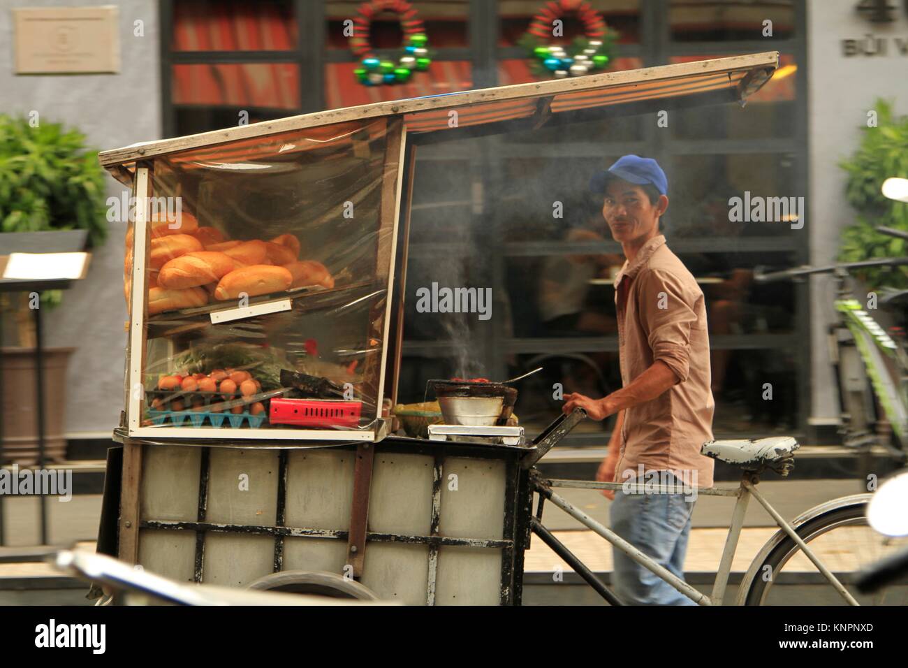 Man pushing food cart through the streets of Ho Chi Minh City, Vietnam ...