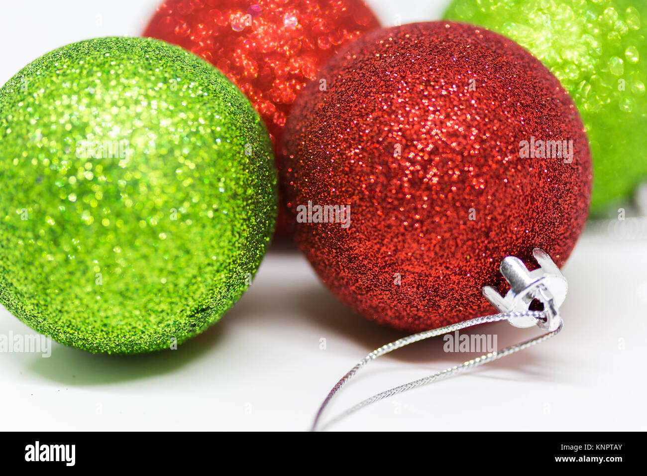 Green and Red Christmas baubles on a white background Stock Photo - Alamy