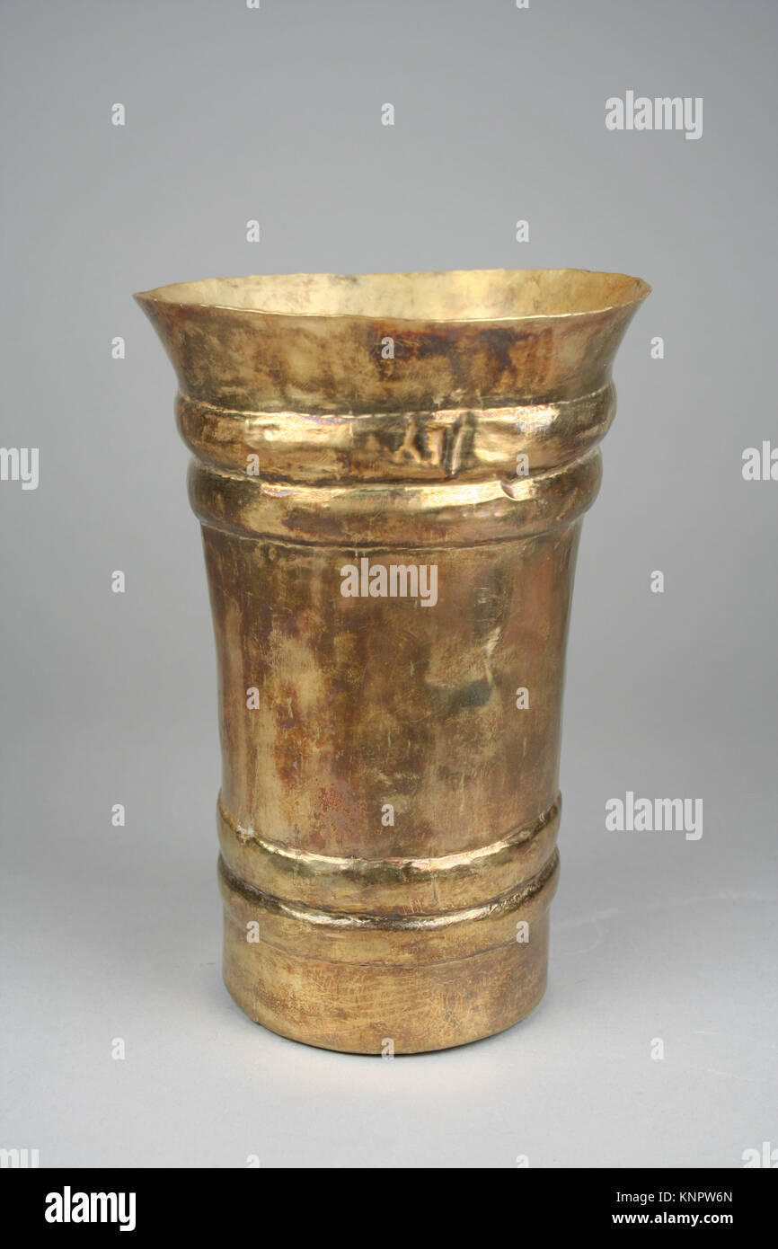 A ceramic beaker featuring a cylindrical form, historically used for ...