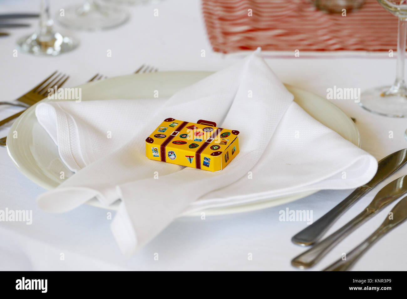 Circle dinner table served with white crockery and decorated with ...