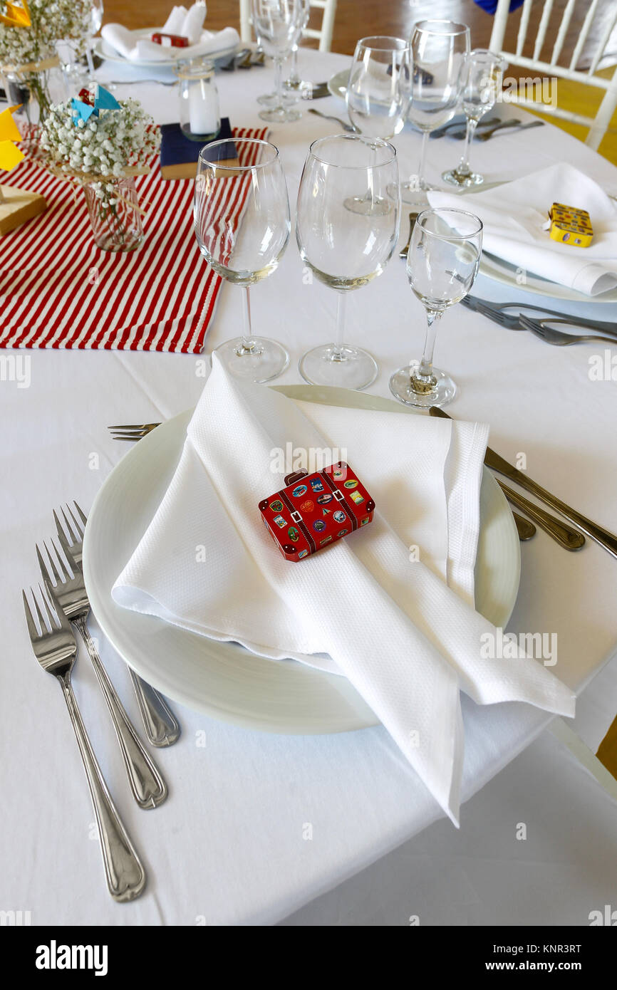 Circle dinner table served with white crockery and decorated with ...