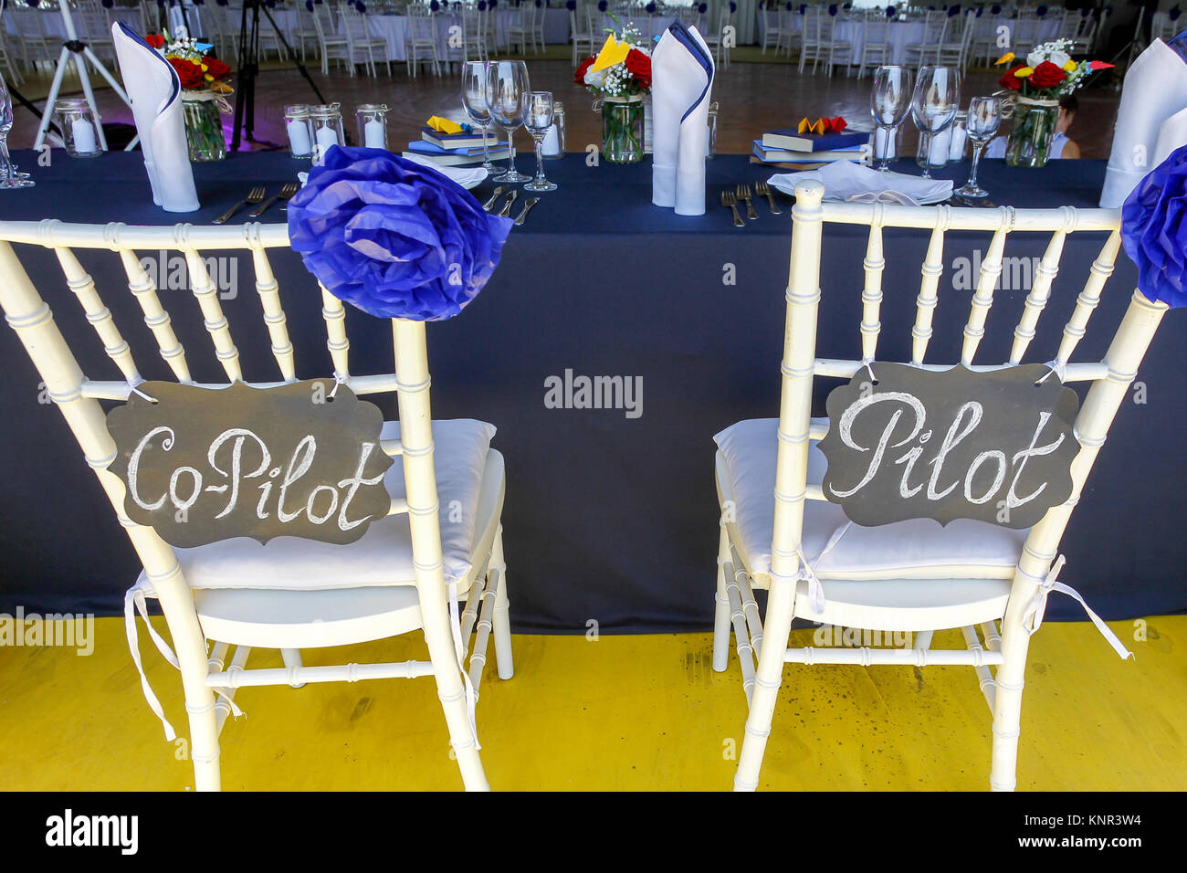 Circle dinner table served with white crockery and decorated with ...