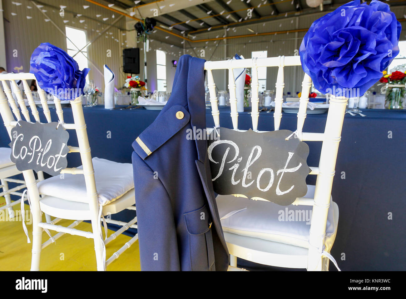 Circle dinner table served with white crockery and decorated with ...