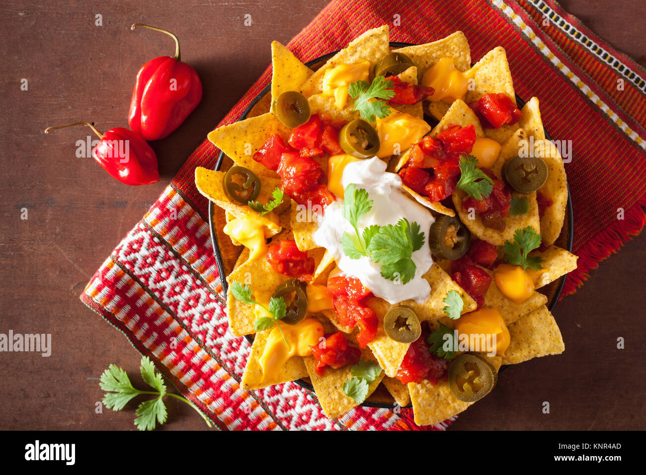 nachos loaded with salsa, cheese and jalapeno Stock Photo - Alamy