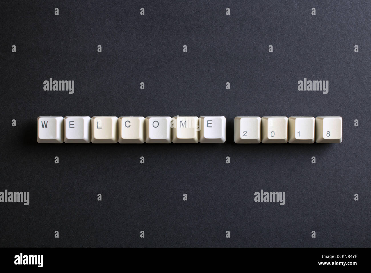 Welcome 2018 New Year. Flat lay view from above on the table with computer keyboard keys buttons ...