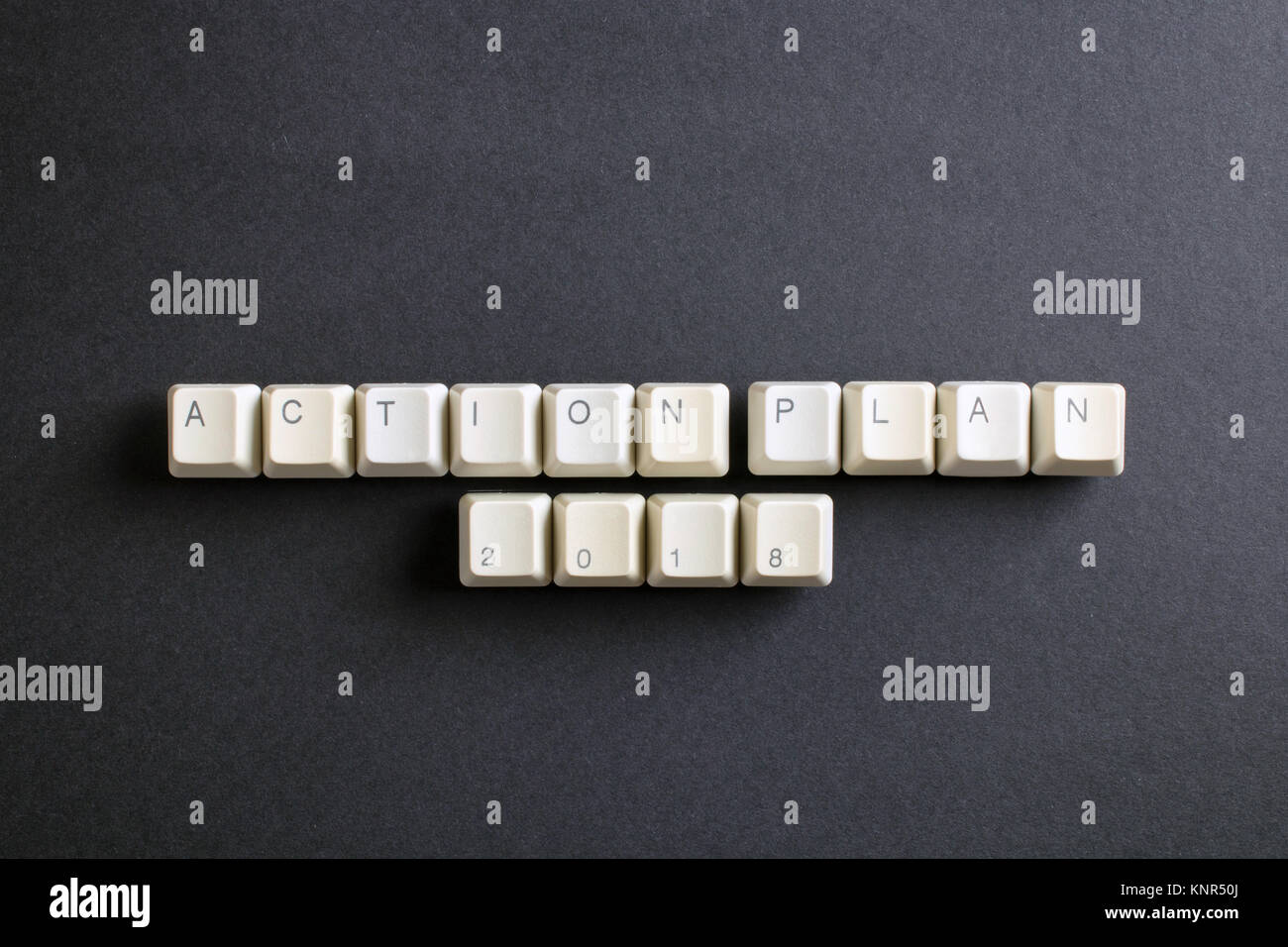 Action plan 2018. Flat lay view from above on the table with computer keyboard keys buttons on a ...
