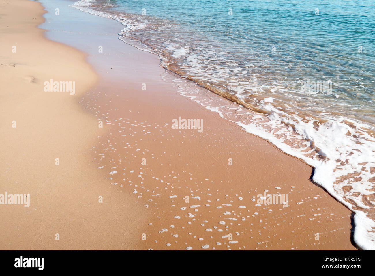 Sandy beach and sea water Stock Photo - Alamy
