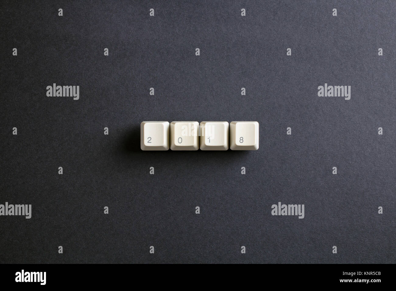 2018 word. Flat lay view from above on the table with computer keyboard keys buttons on a dark ...