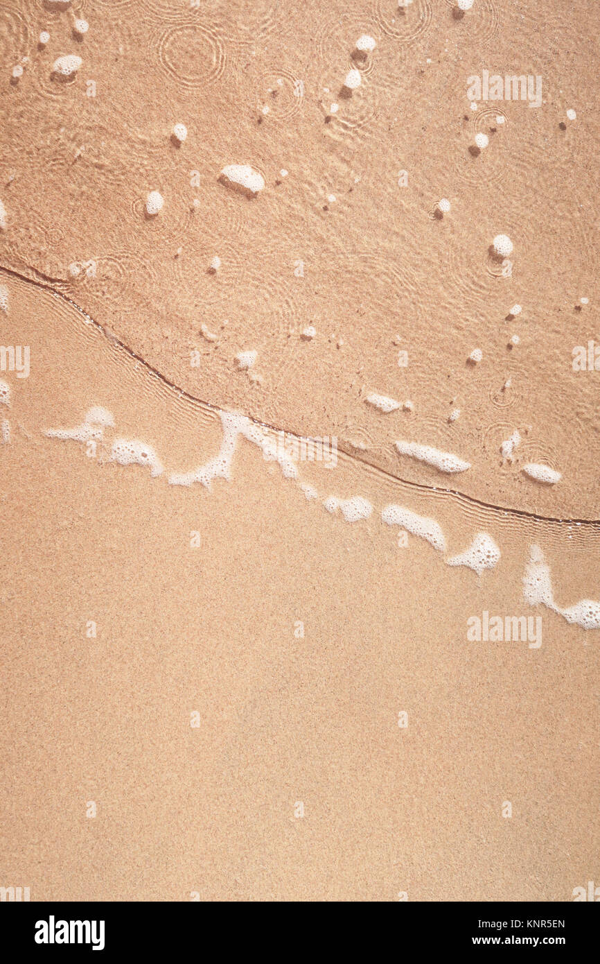 Transparent soft wave on sandy beach Stock Photo - Alamy