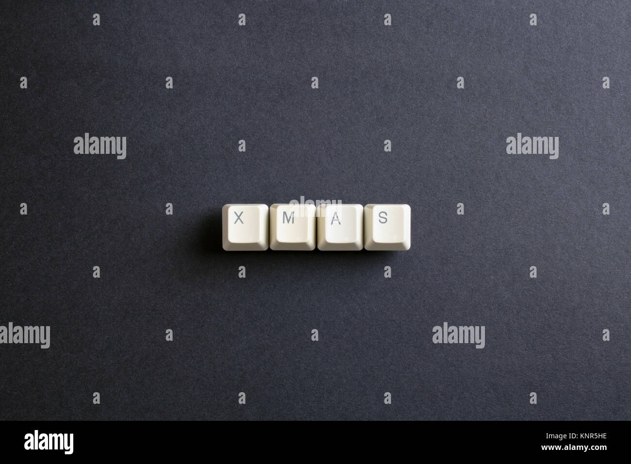 Xmas word. Flat lay view from above on the table with computer keyboard keys buttons on a dark ...