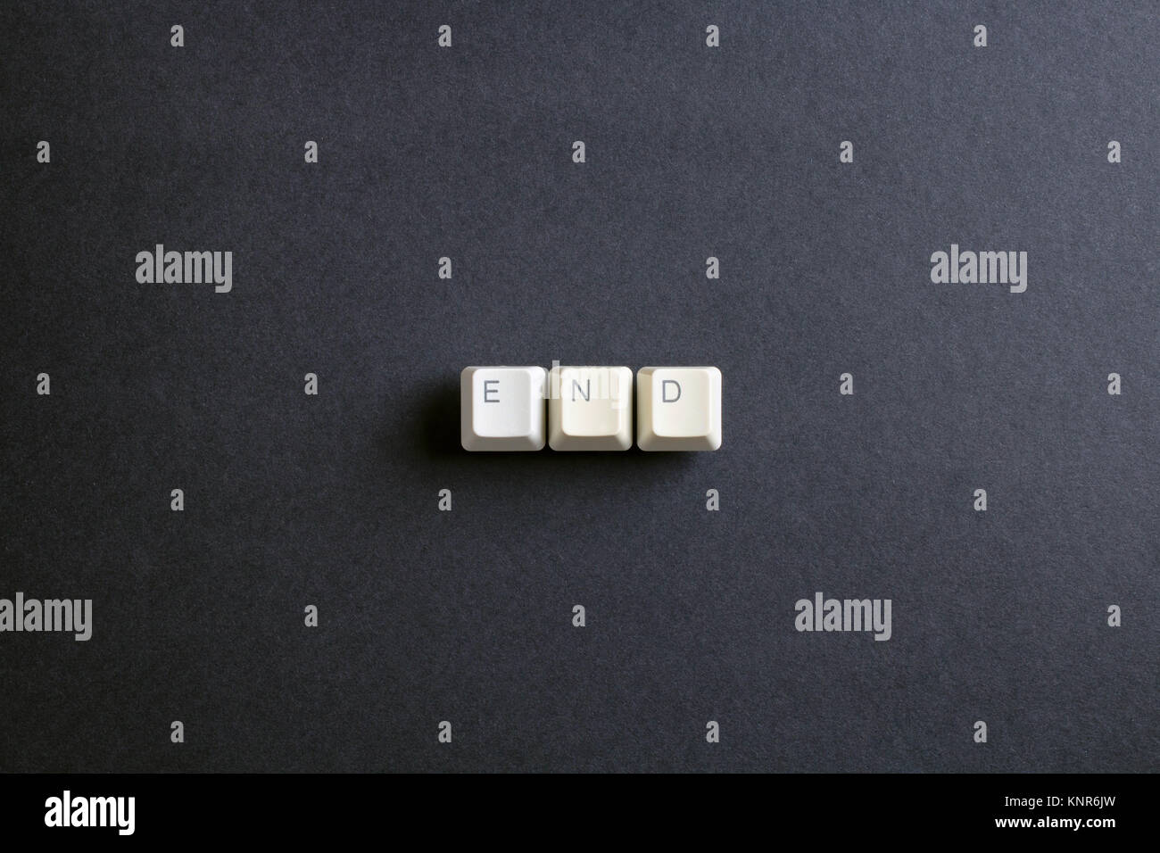 The end. Flat lay view from above on the table with computer keyboard keys buttons on a dark ...