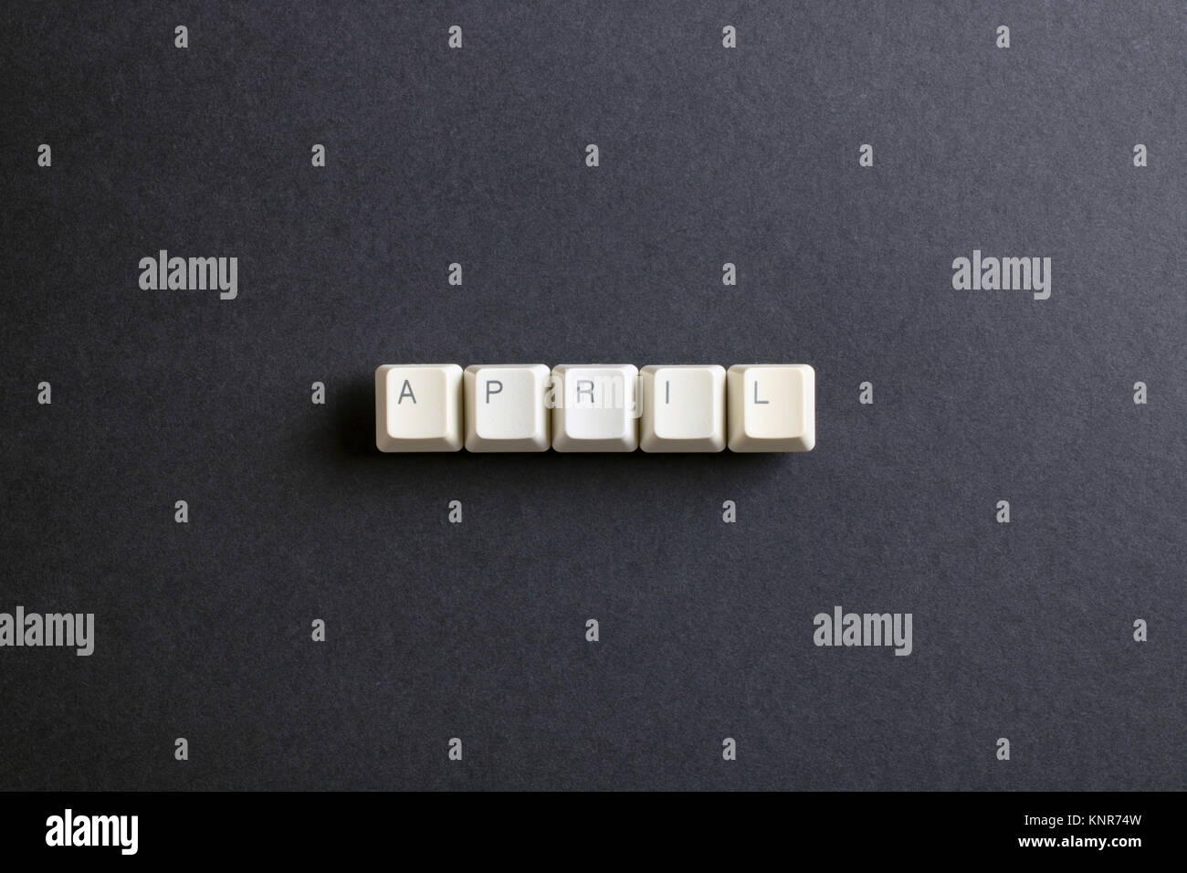 April month word is written with computer keys button. Flat lay view ...