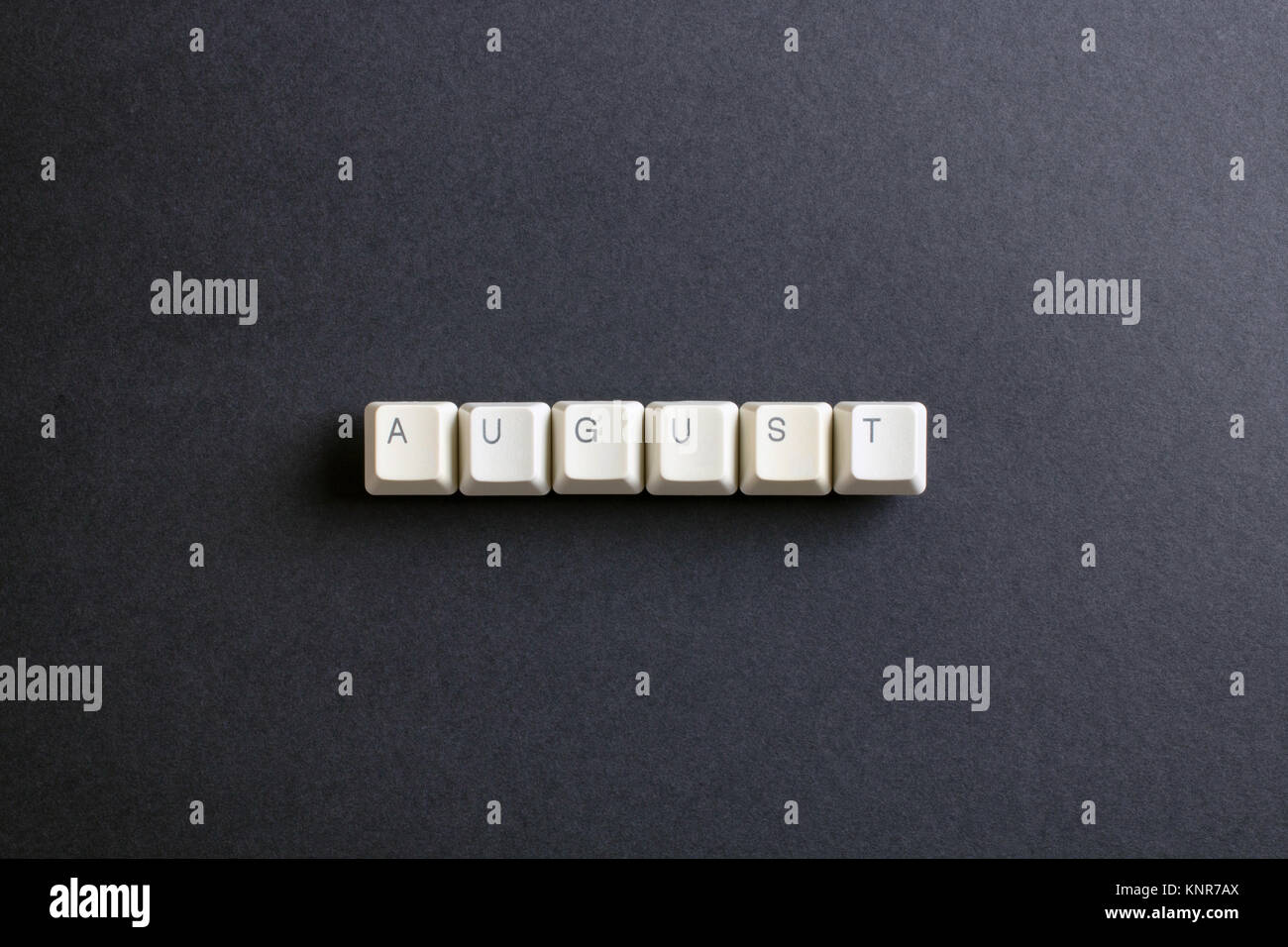 August month word is written with computer keys button. Flat lay view from above on the table ...