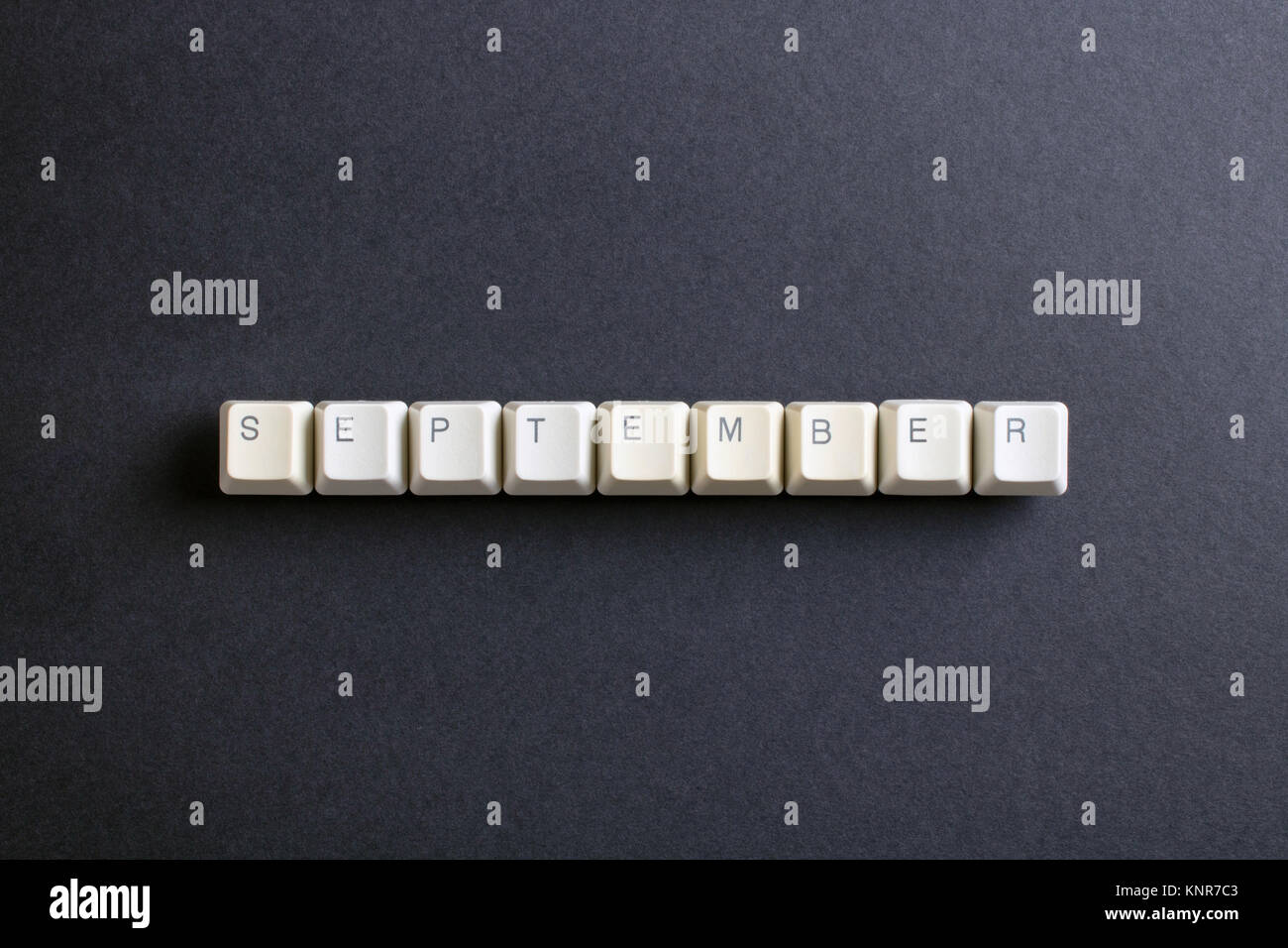 September month word is written with computer keys button. Flat lay view from above on the table ...