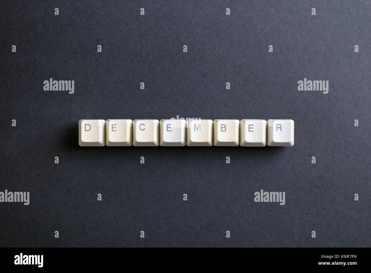 December month word is written with computer keys button. Flat lay view from above on the table ...