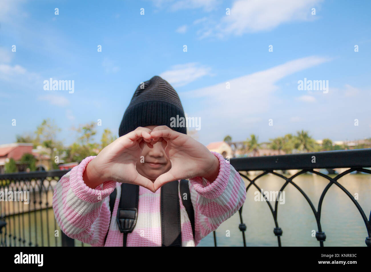 Asian little girl showing hand make heart shape with happiness in ...