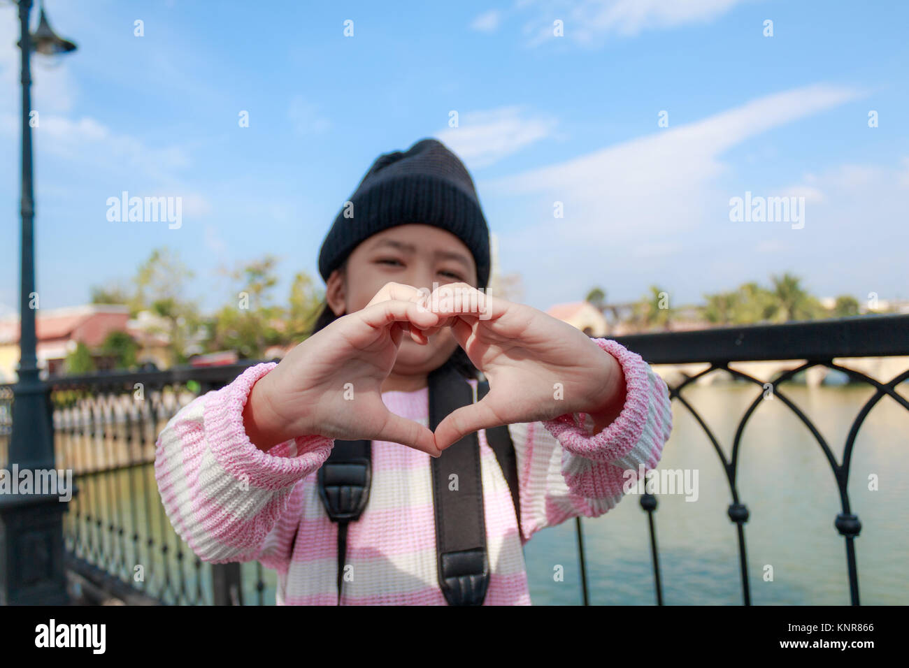 Asian little girl showing hand make heart shape with happiness in ...