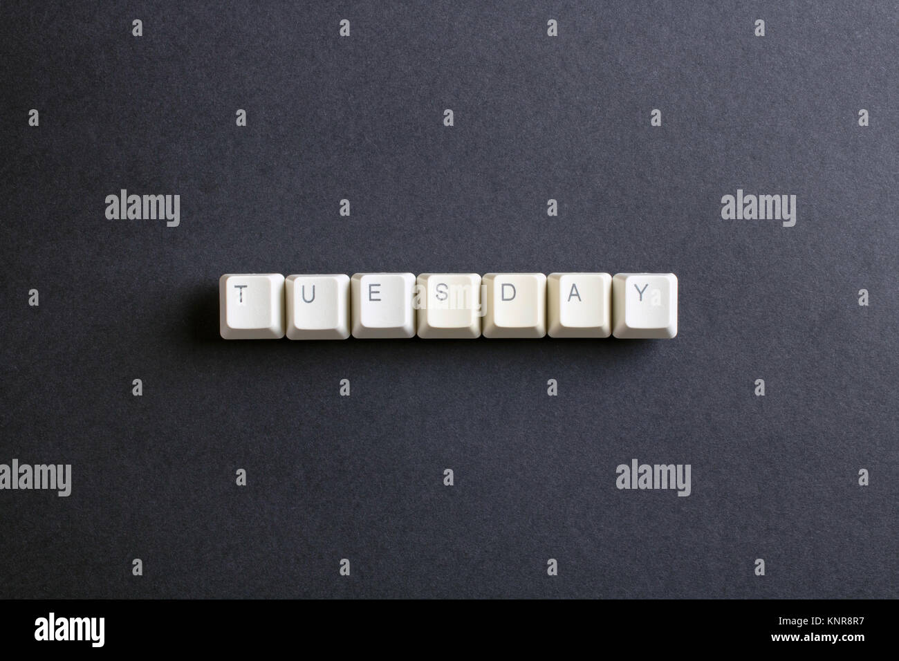 Tuesday word on computer keys button. Flat lay view from above on the table with computer ...
