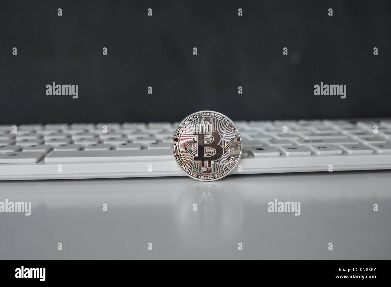 Silver coin bitcoin. BTC. cryptocurrency symbol on keyboard background ...
