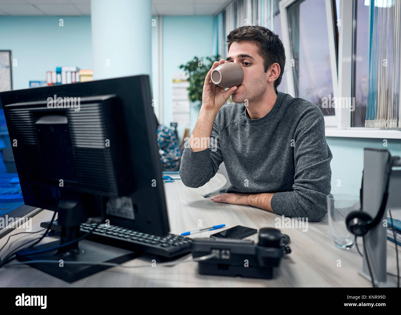 man working at computer in office Stock Photo - Alamy