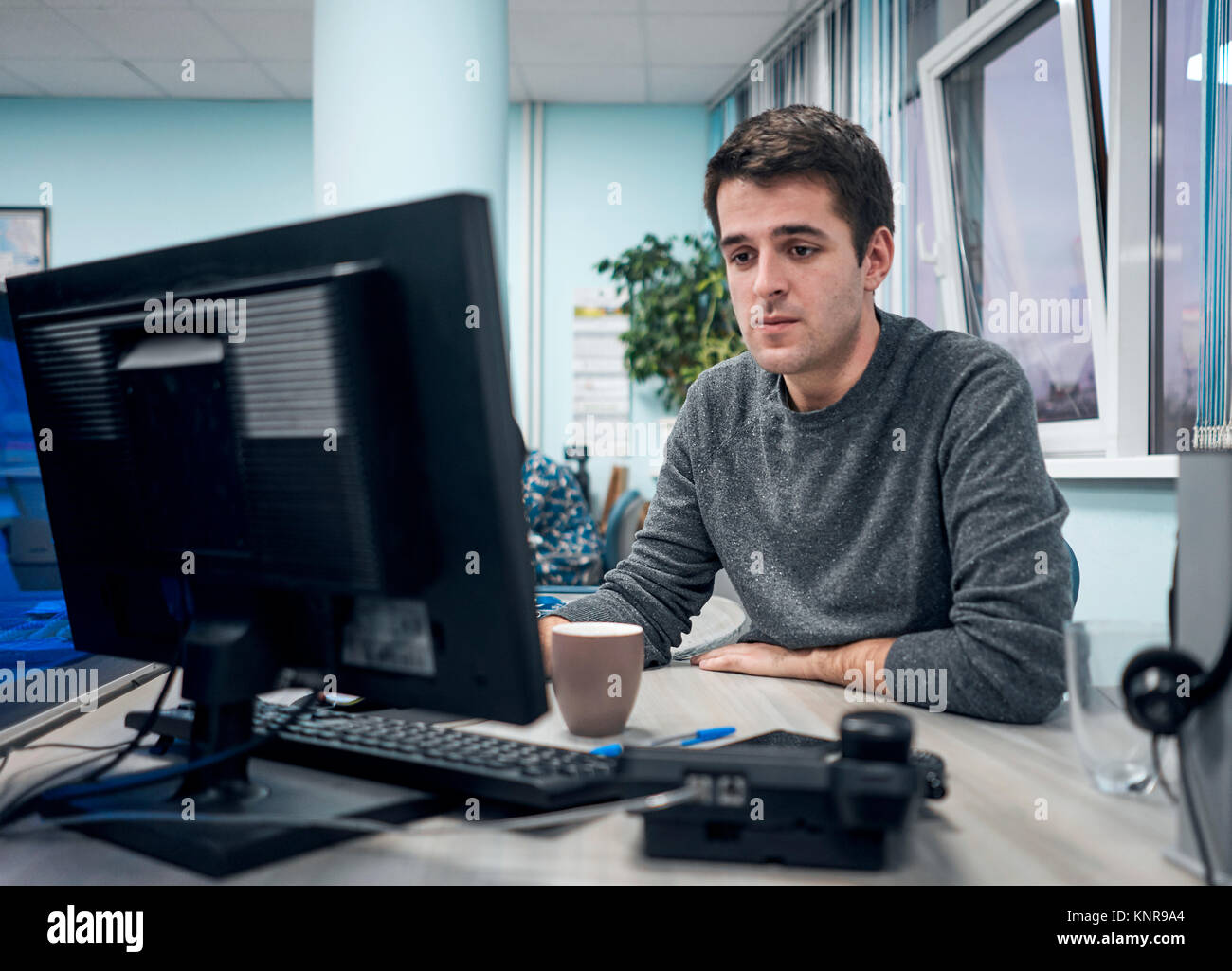 man working at computer in office Stock Photo - Alamy