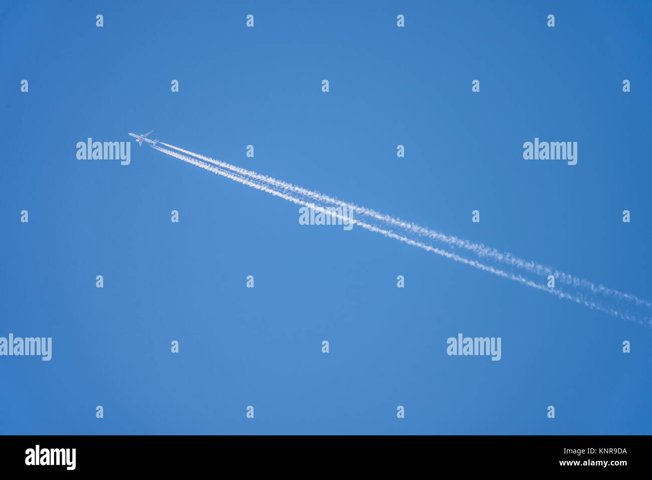 Contrails. Jet airliner plane flying at altitude leaving contrails ...