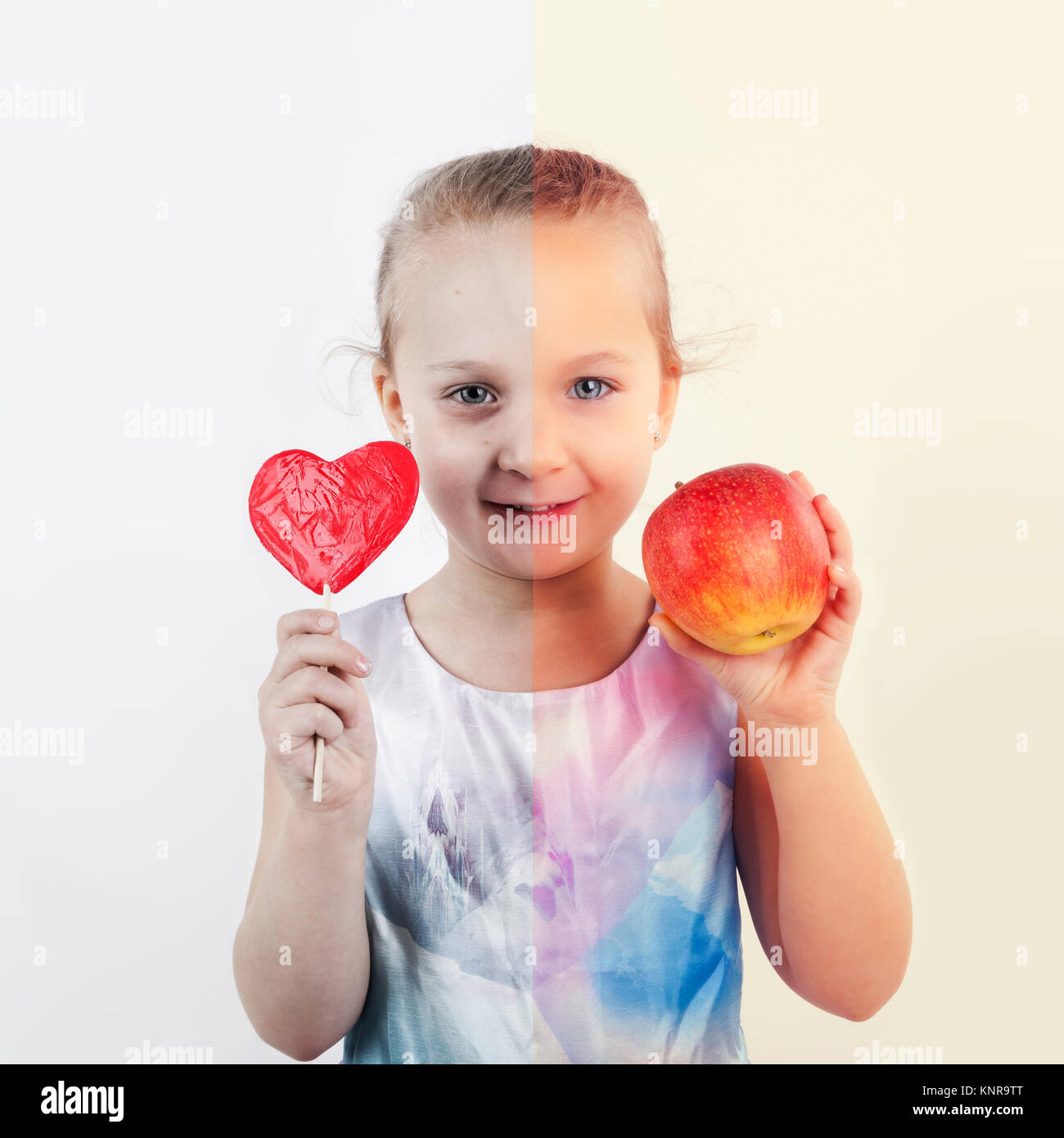 Lifestyle choice. Cute little girl choosing between apple and candy ...