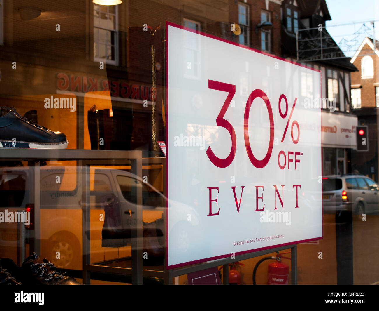 30 percent event sign advertising price discounts in shoe shop window ...