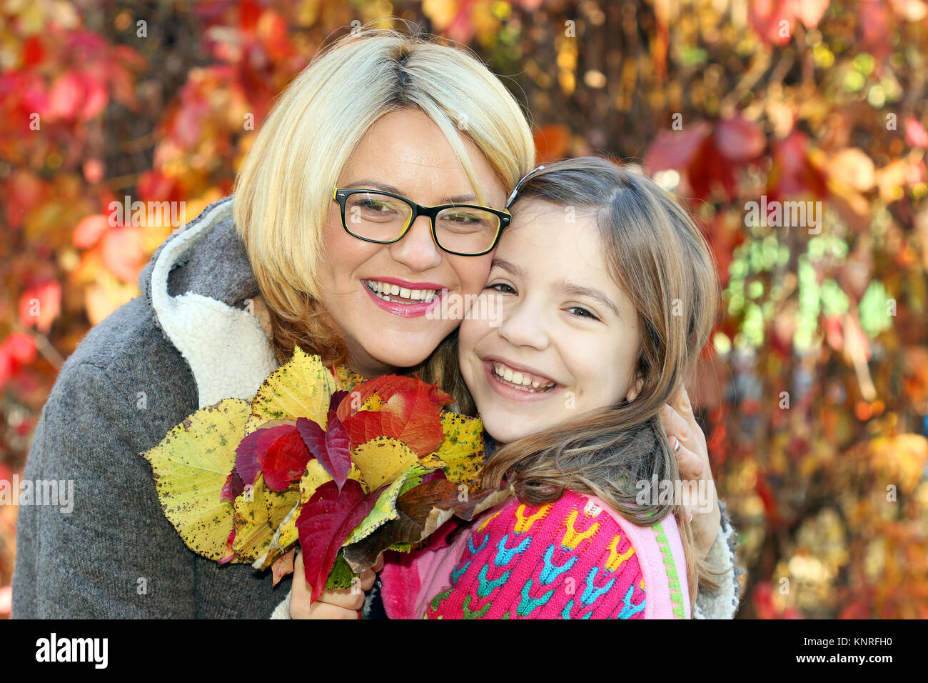 mother and daughter in park autumn season Stock Photo - Alamy