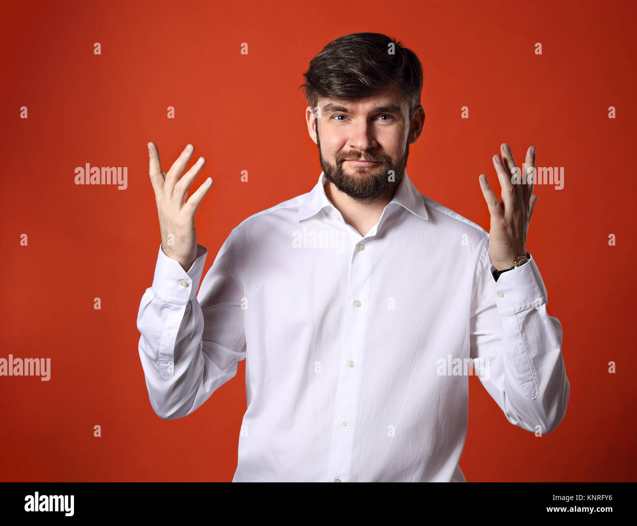 Confused puzzled funny bearded man in white shirt gesturing the hands ...