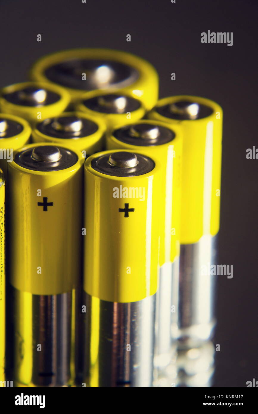 Yellow double A batteries reflecting in mirror, electricity storage ...