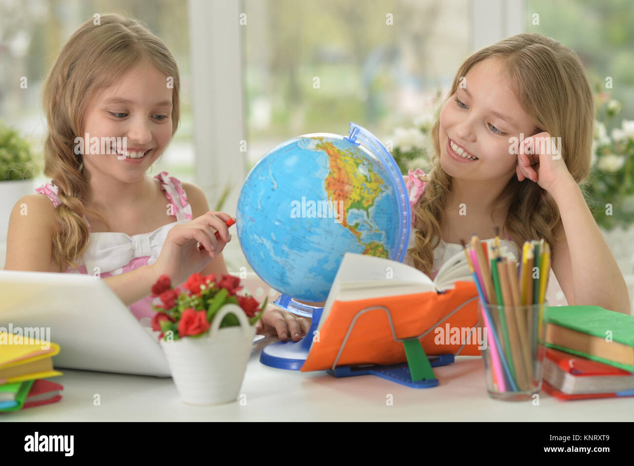 two sisters twins doing homework Stock Photo - Alamy