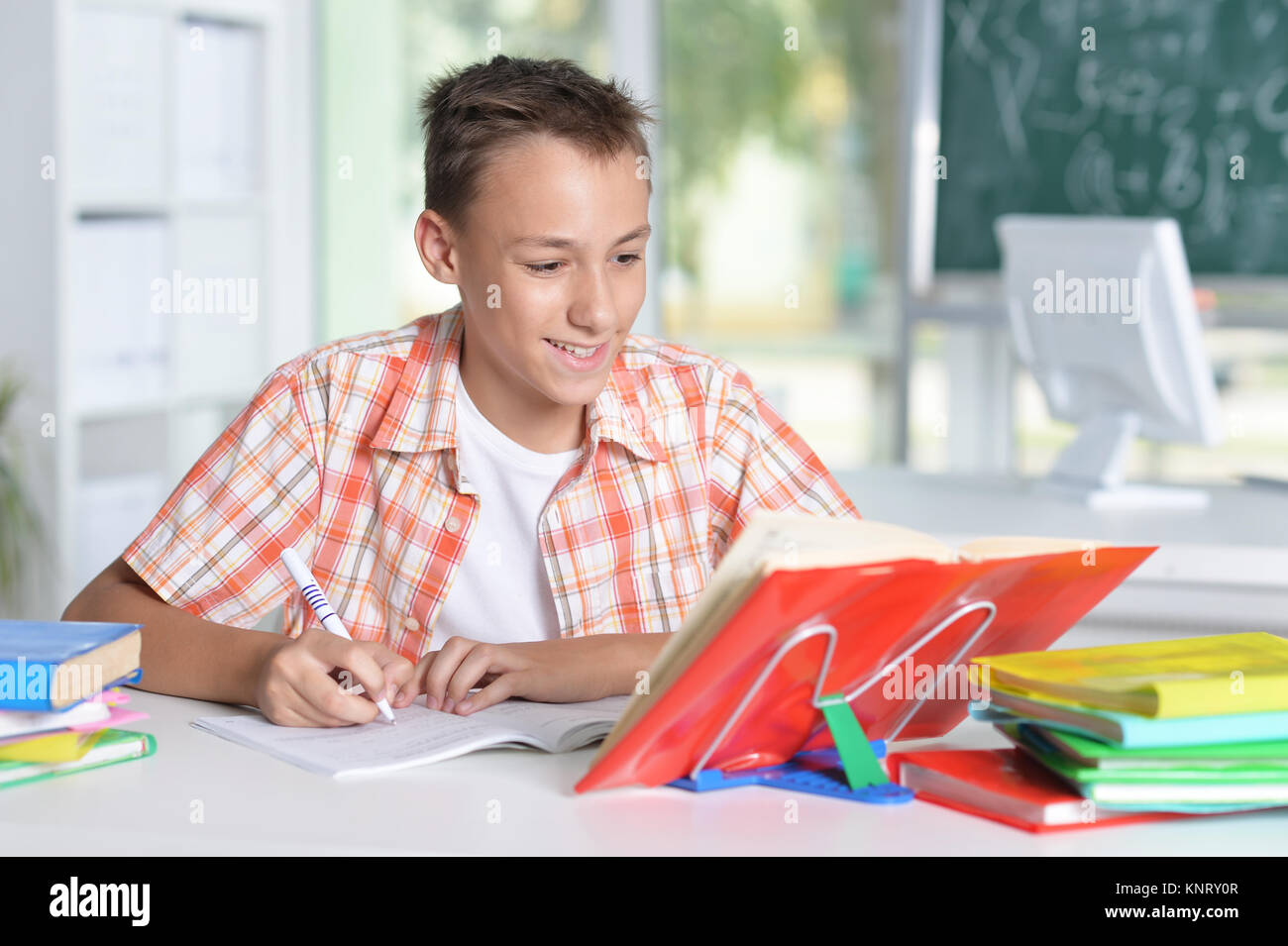 schoolboy doing homework Stock Photo - Alamy