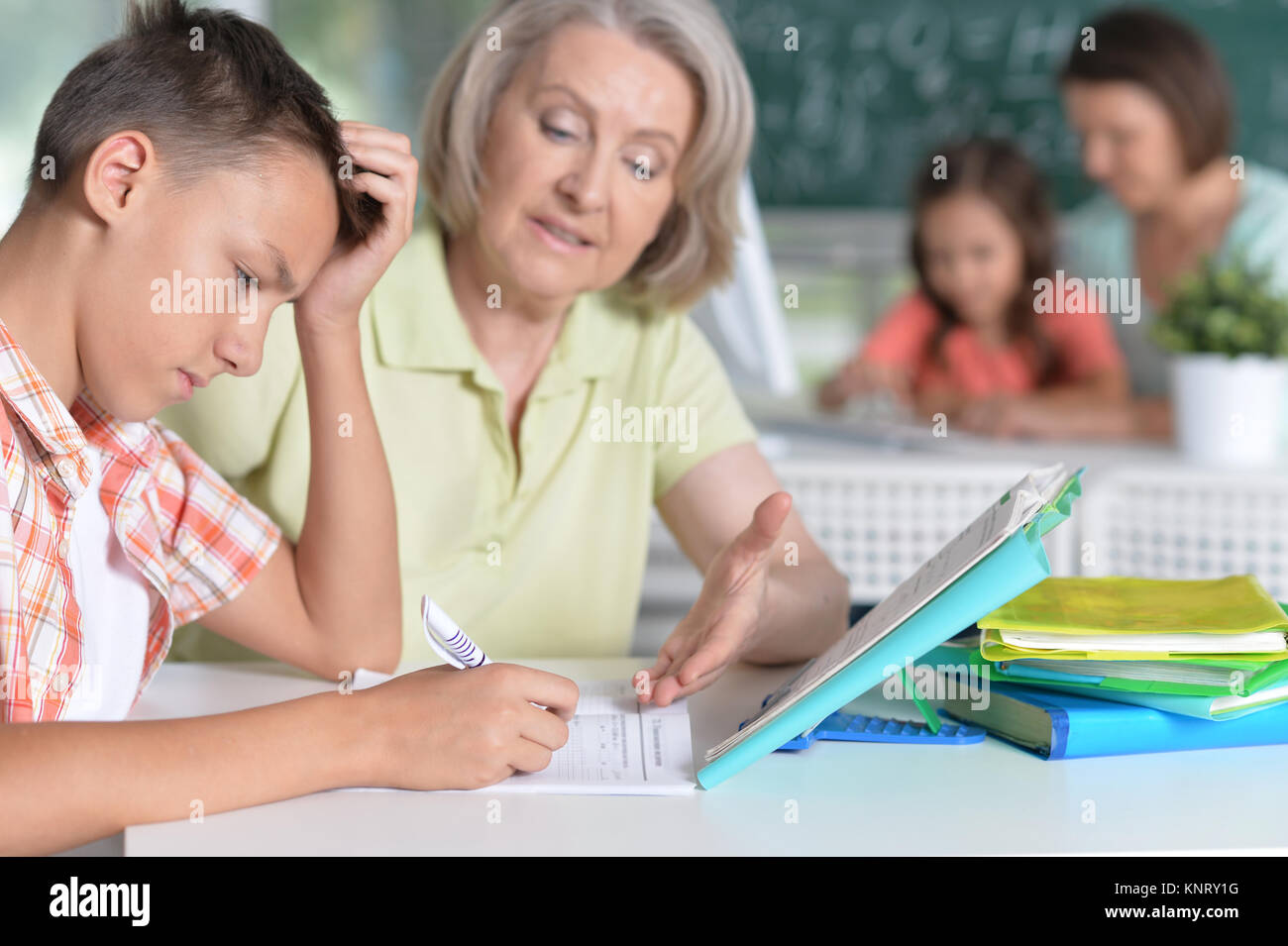 Teachers working with pupils Stock Photo - Alamy