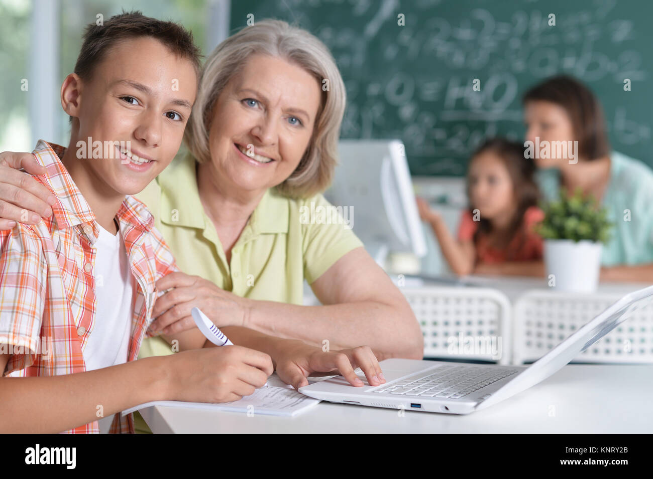 Teachers working with pupils Stock Photo - Alamy