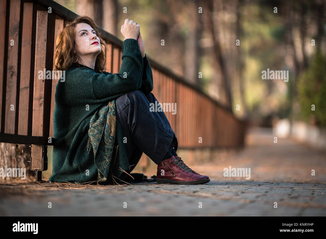 Atractive Woman by a Wooden Fence in the Forest, Thinking and ...