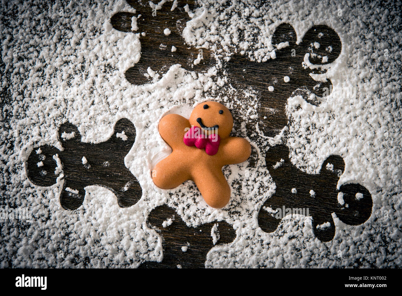 Sprinkled icing sugar over cake decorations and small wooden Christmas ...