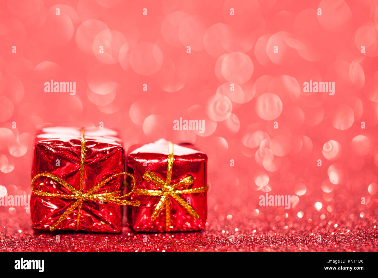 Decorated red holiday gifts on glitter background Stock Photo - Alamy