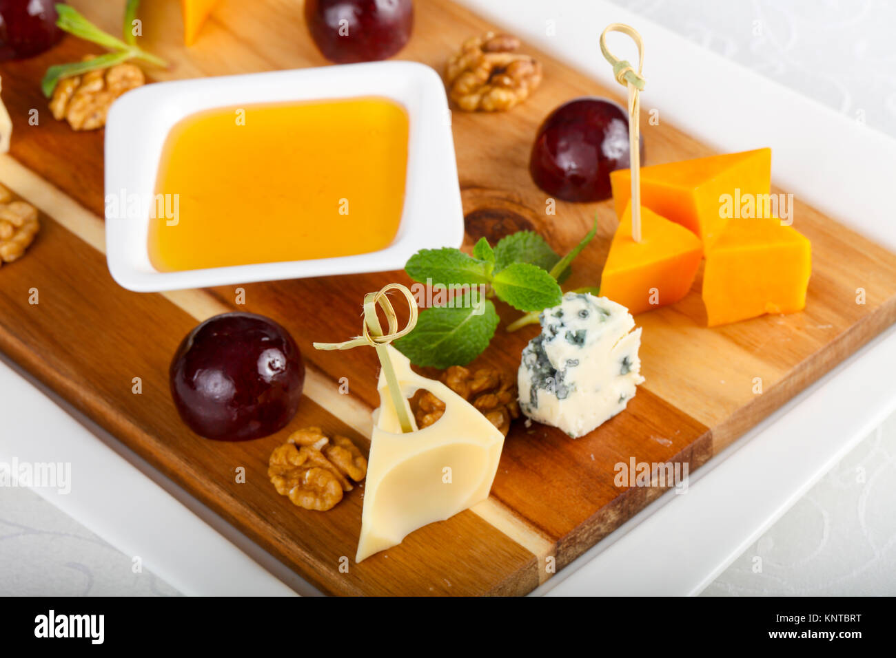 Cheese plate mix with grape, honey and nuts Stock Photo - Alamy