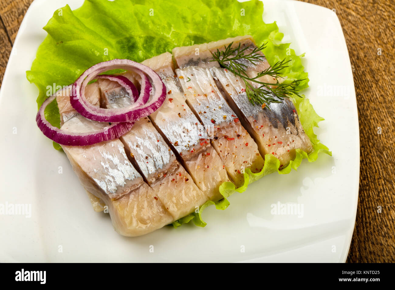 Sliced Herring fillet with dill and onion Stock Photo - Alamy