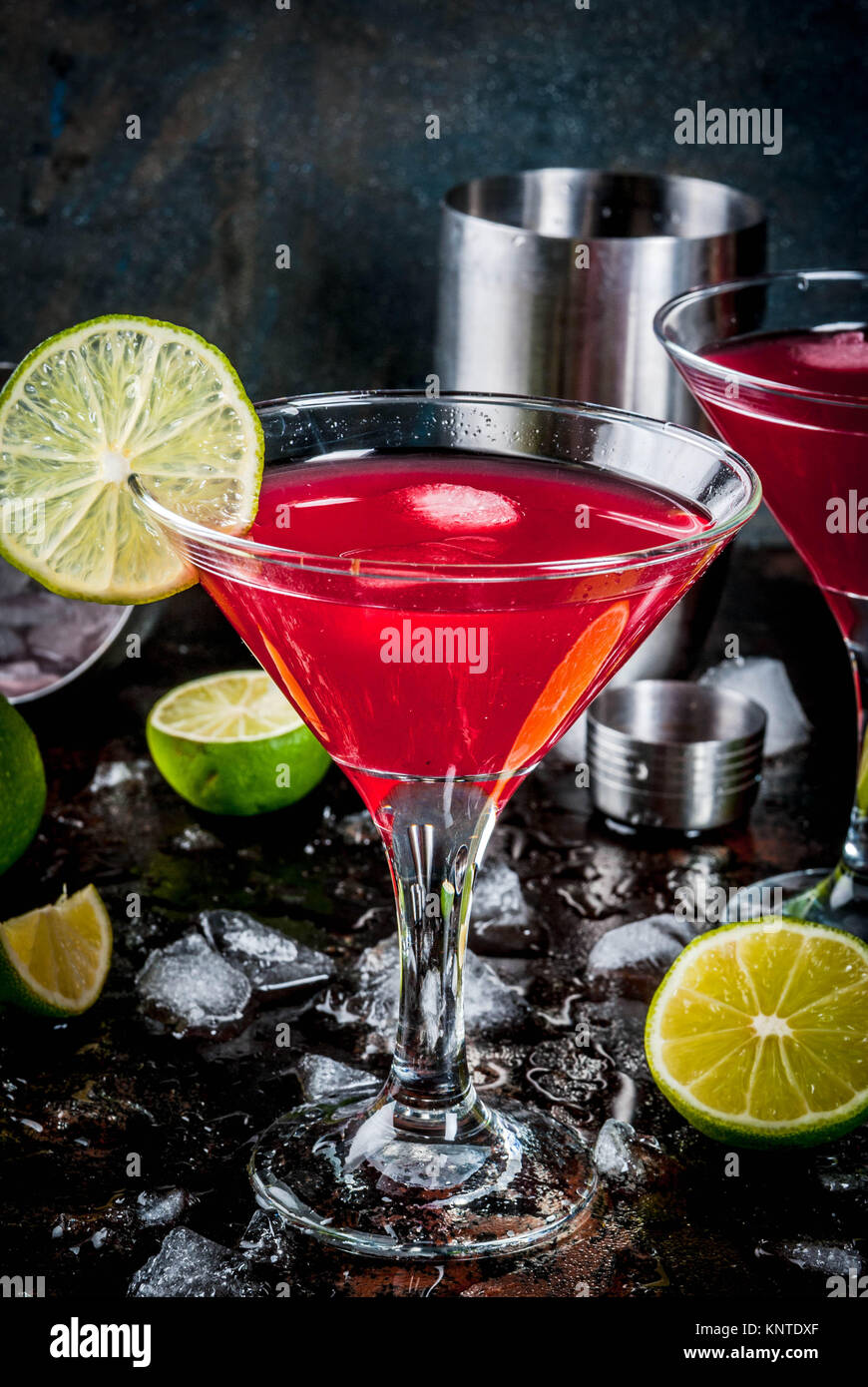 Red cosmopolitan cocktail with lime in martini glass, on dark rusty ...
