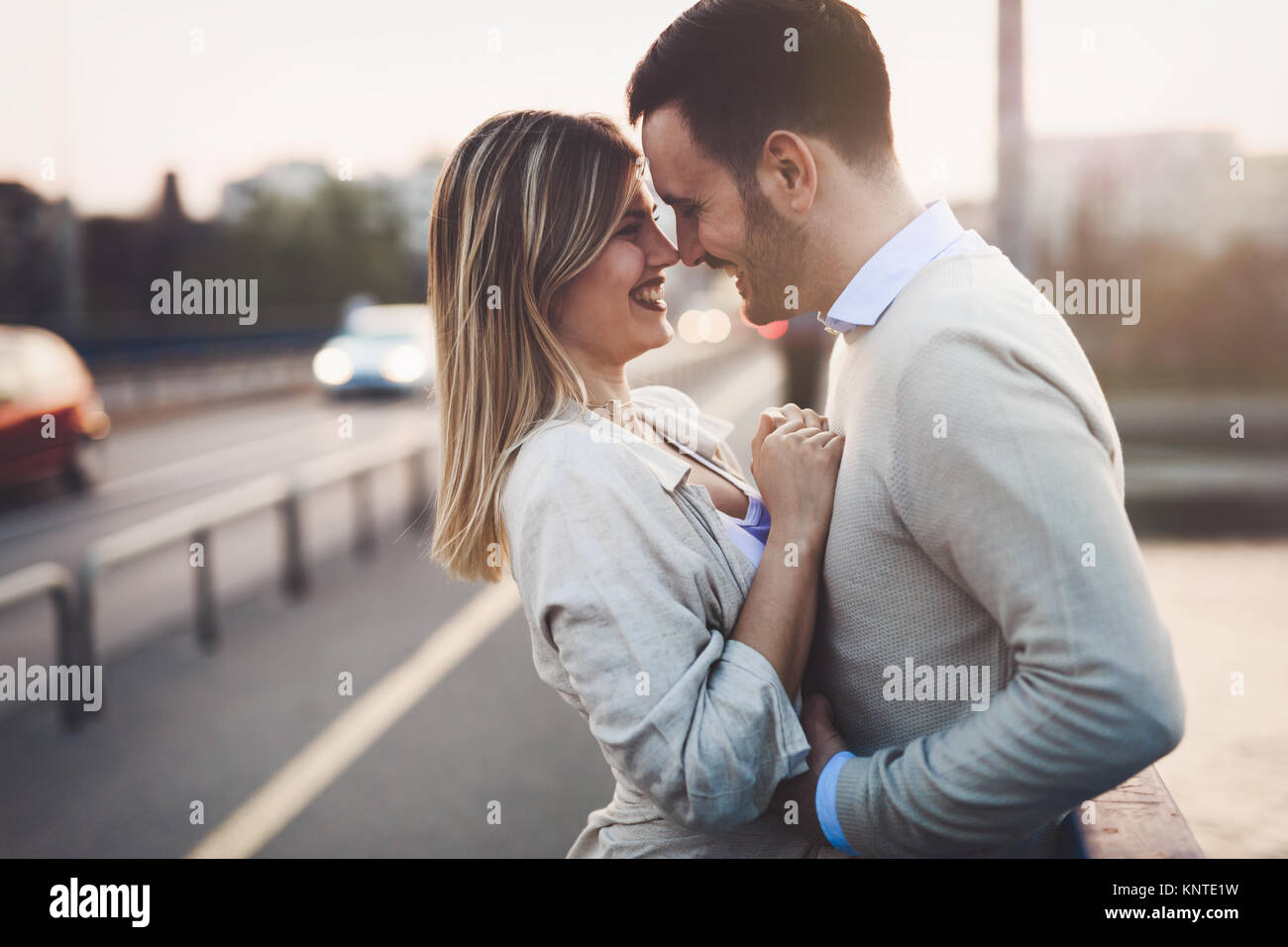 Happy romantic couple hugging and smiling Stock Photo - Alamy