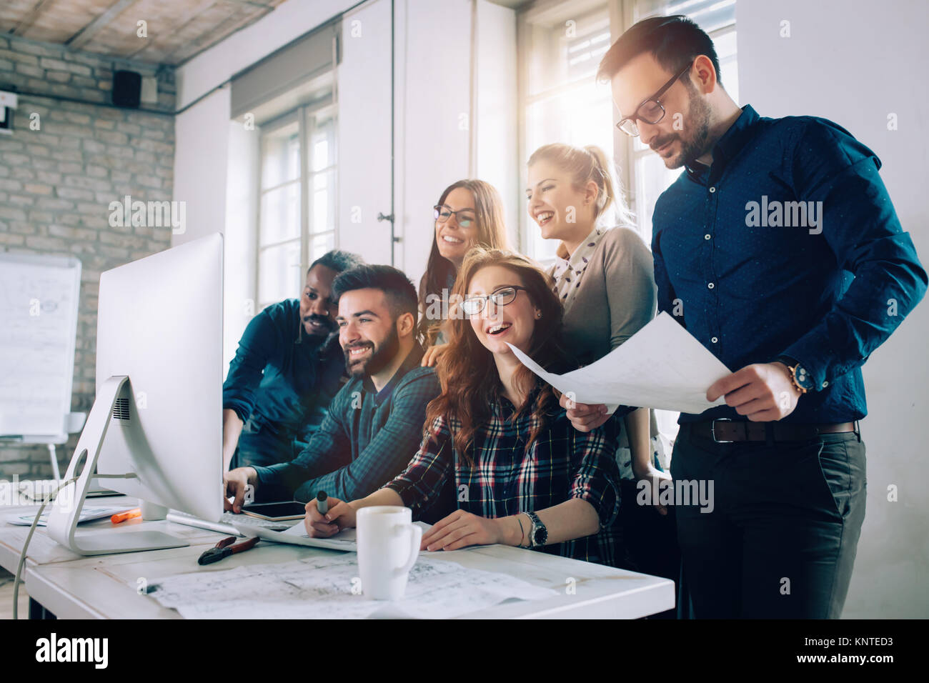 Happy creative coworkers working in designer office Stock Photo - Alamy