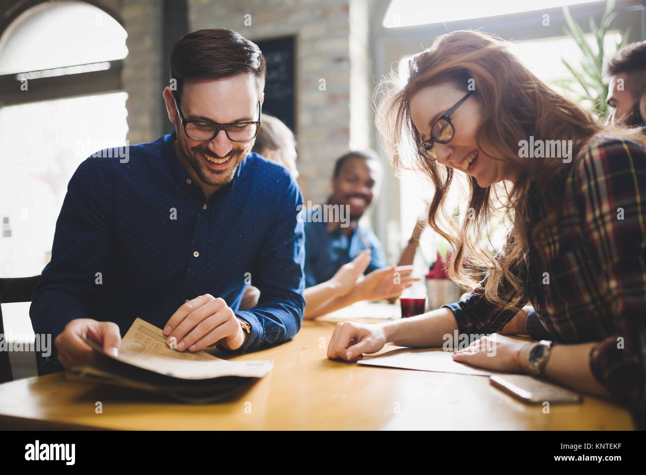 Flirting coworkers eating out and dating in restaurant Stock Photo - Alamy