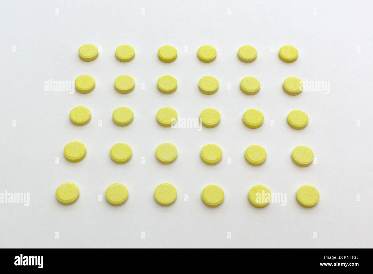 tablets yellow color with no stripes for division, arranged in slender ...
