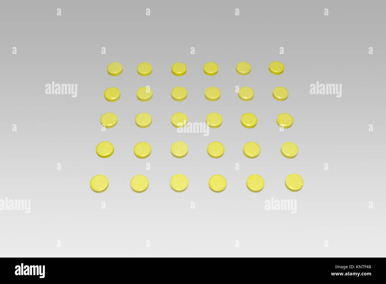 tablets, arranged in neat shape square matrix. yellow Stock Photo - Alamy